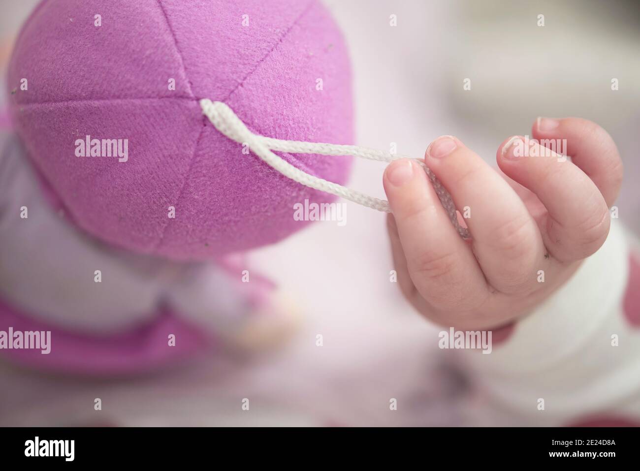 cute little baby playing with hands and smiling Stock Photo - Alamy