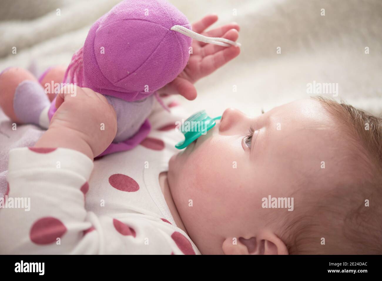cute little baby playing with hands and smiling Stock Photo - Alamy