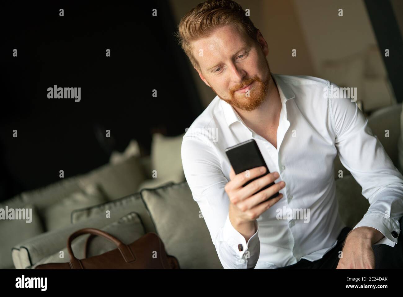Businessman using smartphone looking stock hi-res stock photography and ...