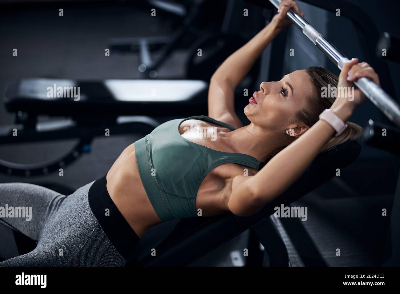 Young woman weightlifting on bench hi-res stock photography and images ...