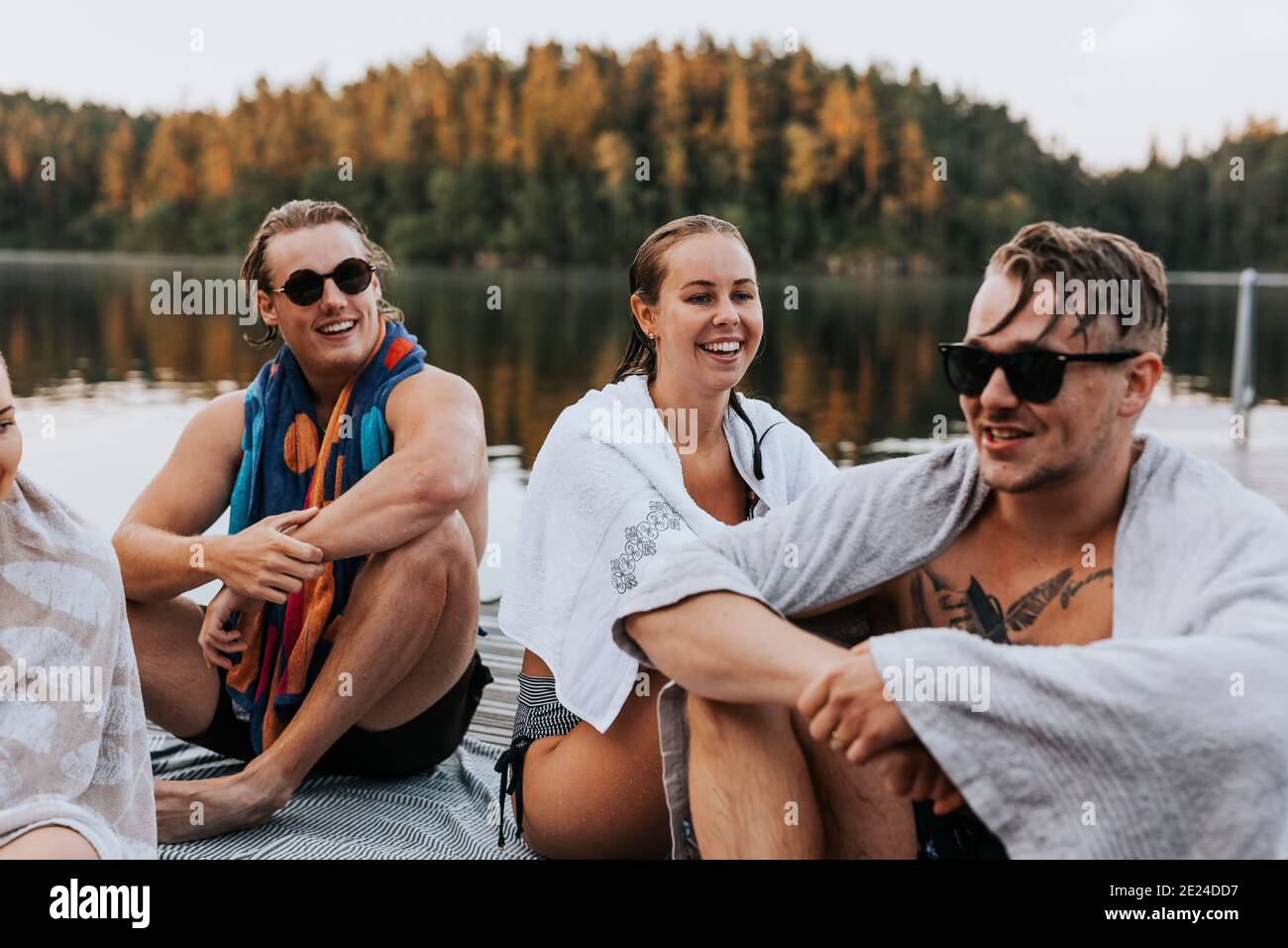 Young man sitting on jetty hi-res stock photography and images - Alamy