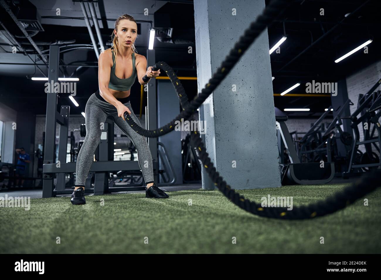 Anxious lady slamming the battle ropes on the floor Stock Photo - Alamy