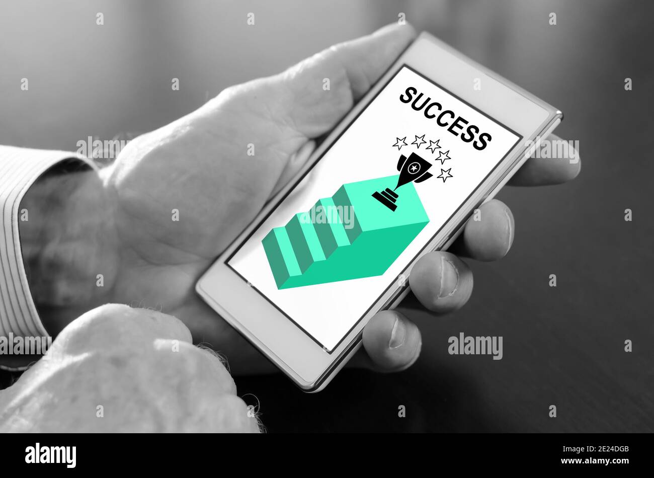 Hand holding a smartphone with success concept Stock Photo - Alamy