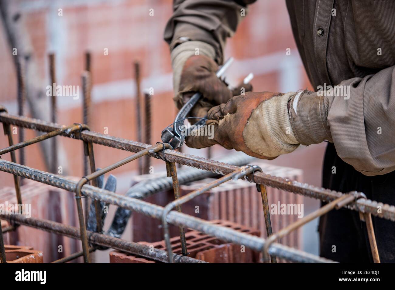 Construction worker installing binding wires on the reinforcement Stock ...