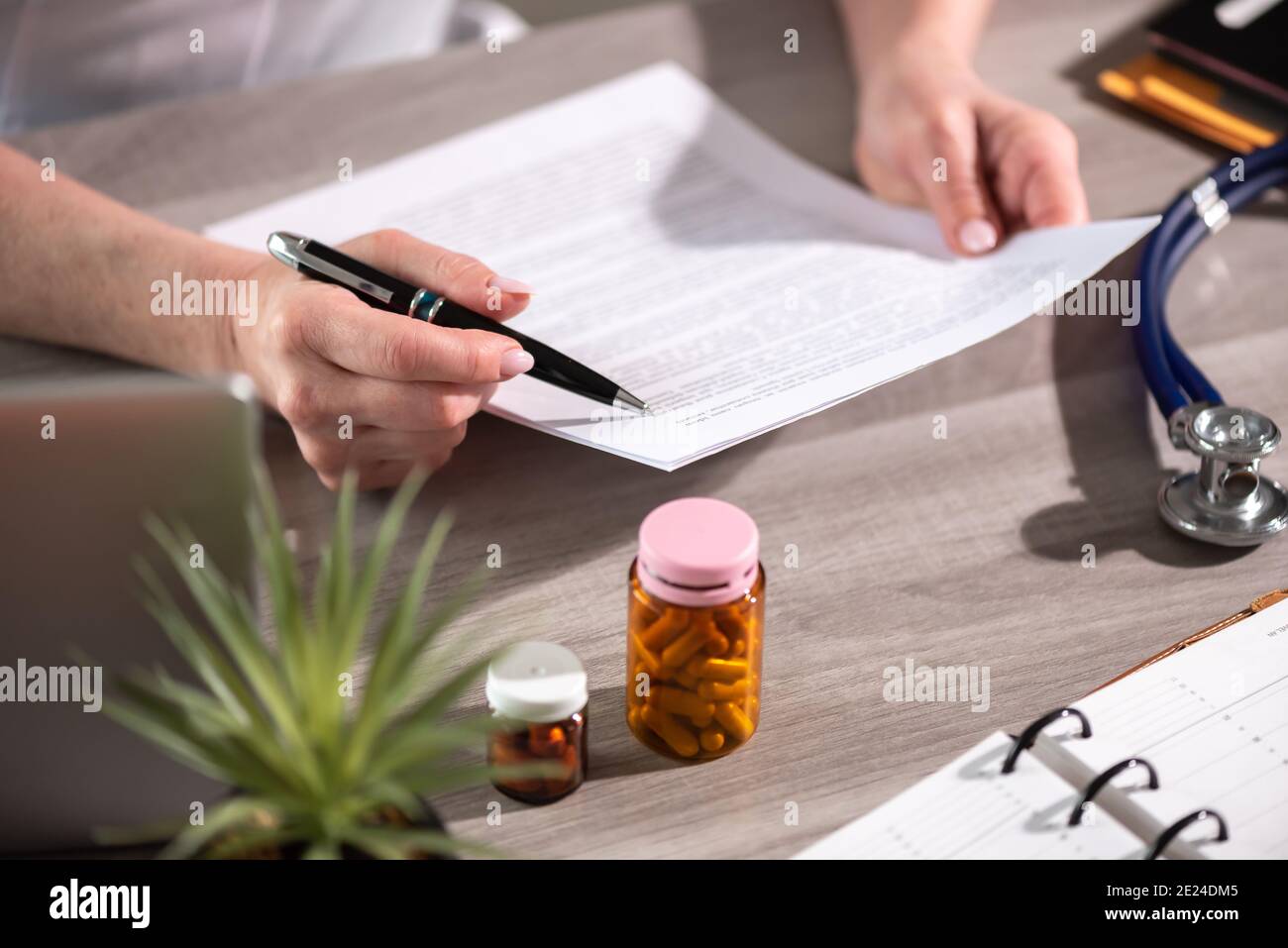 Female doctor reading medical report in medical office Stock Photo - Alamy