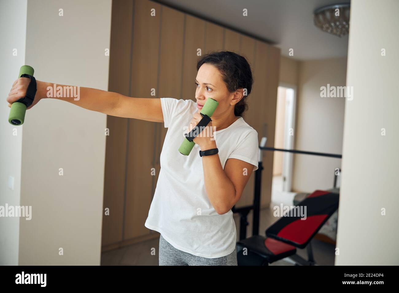 Woman boxer performing a dumbbell punch exercise Stock Photo - Alamy