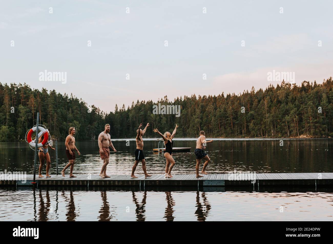 Friends having fun on jetty Stock Photo - Alamy