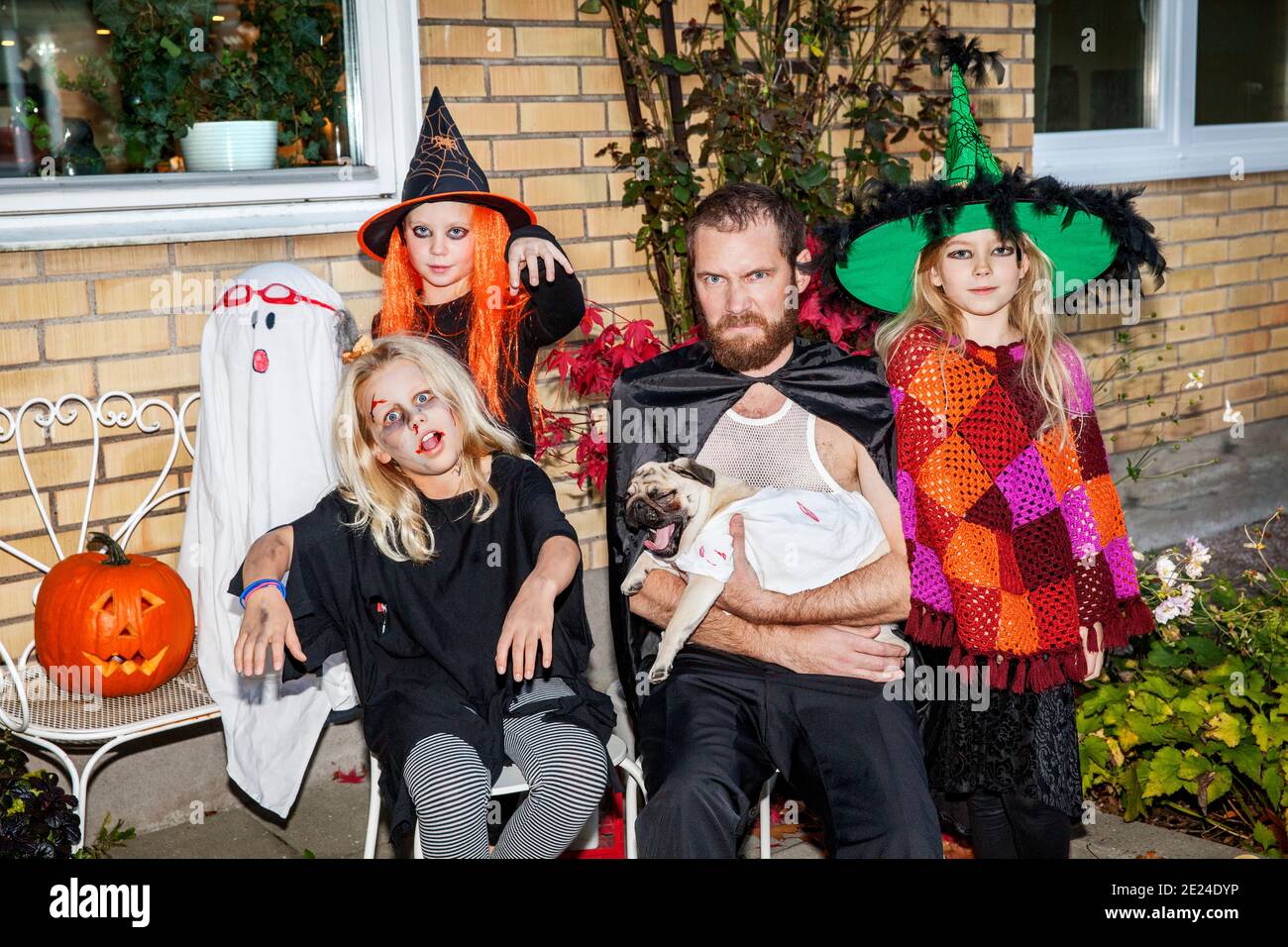 Father with daughters wearing Halloween costumes Stock Photo - Alamy