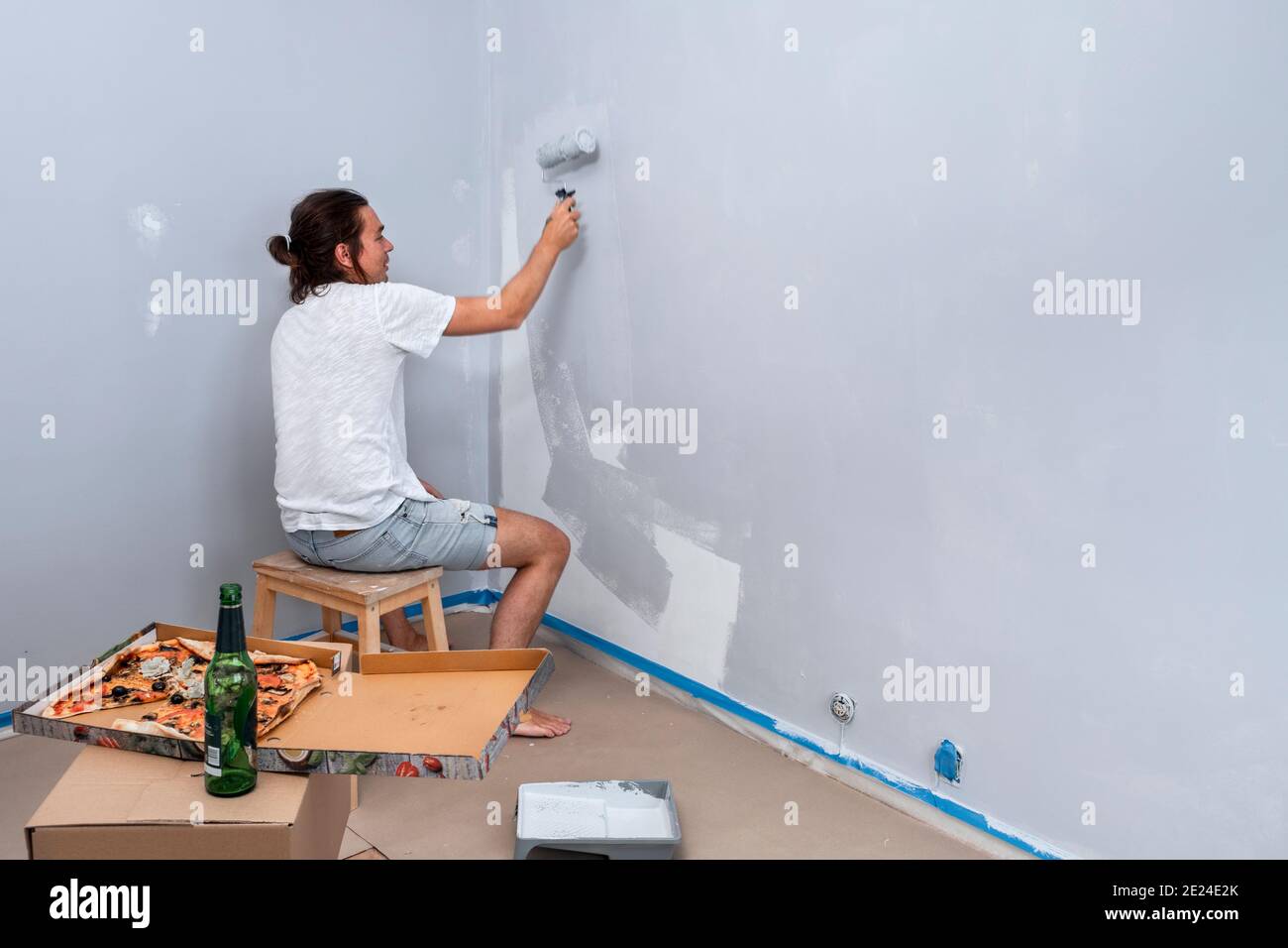 Man painting walls at home Stock Photo - Alamy