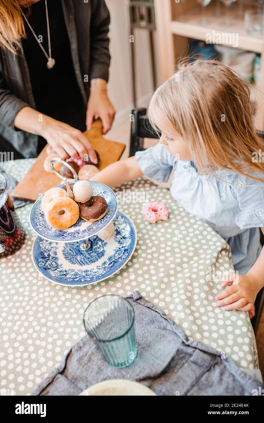 Girl choosing donut Stock Photo - Alamy
