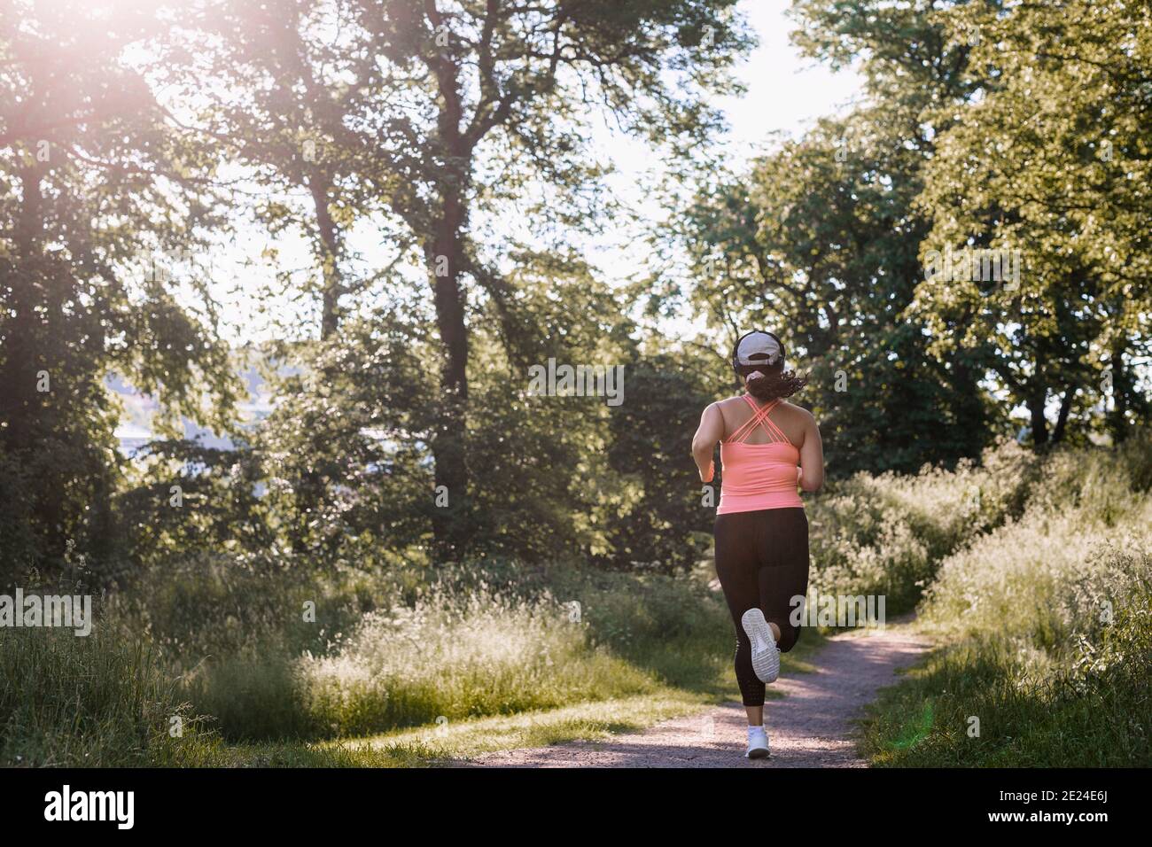 Rear view of woman jogging Stock Photo - Alamy