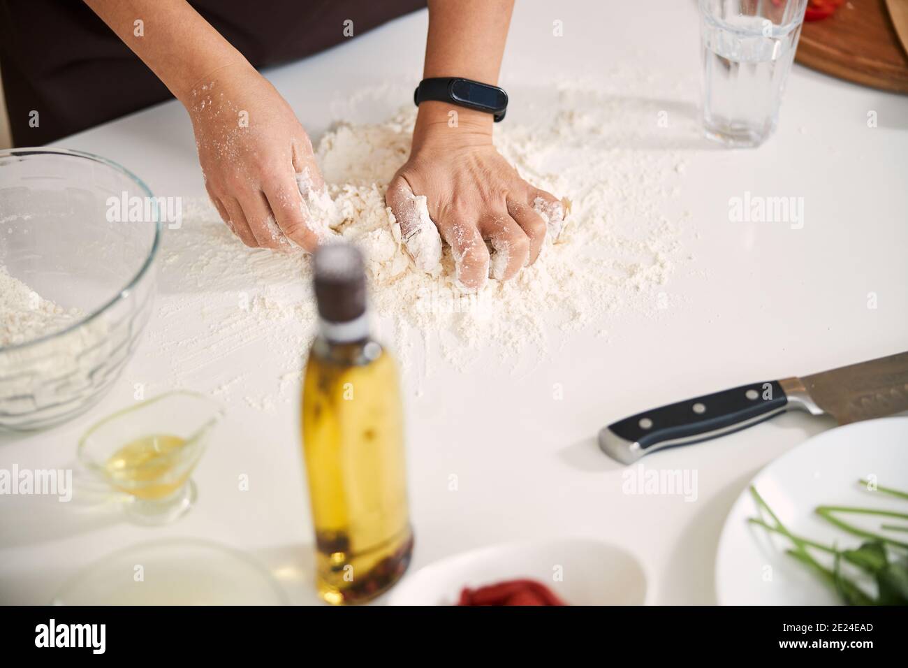 Quick movements of hands while working with dough Stock Photo - Alamy