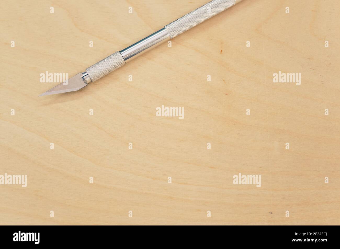 Top view of the metallic scalpel on a plywood surface Stock Photo - Alamy