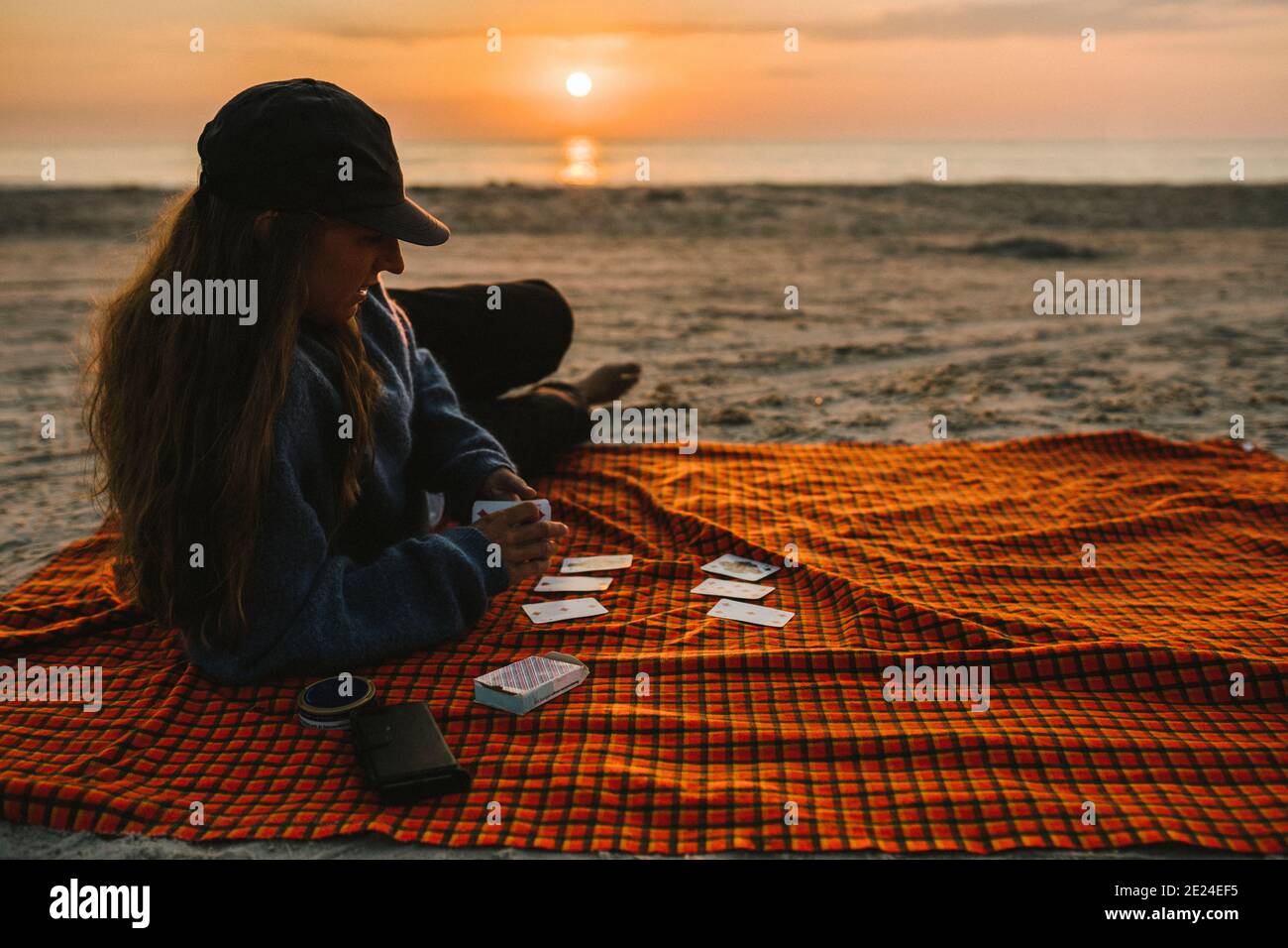 Woman playing cards on beach Stock Photo - Alamy