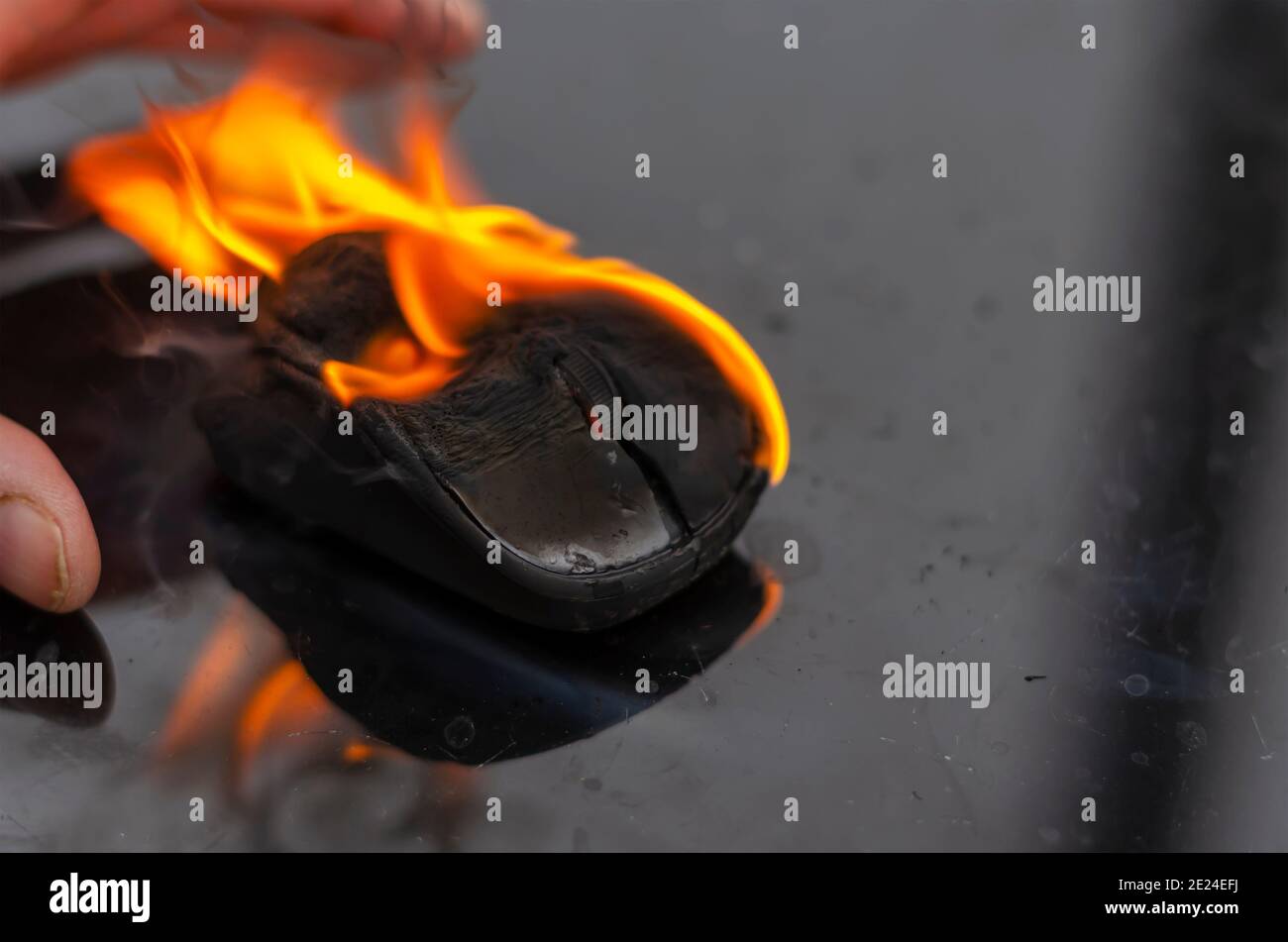 Household electrical appliance fire concept. Wireless computer mouse is ...