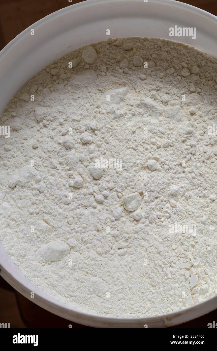 Large plastic bucket of wheat flour. An ingredient for preparing ...