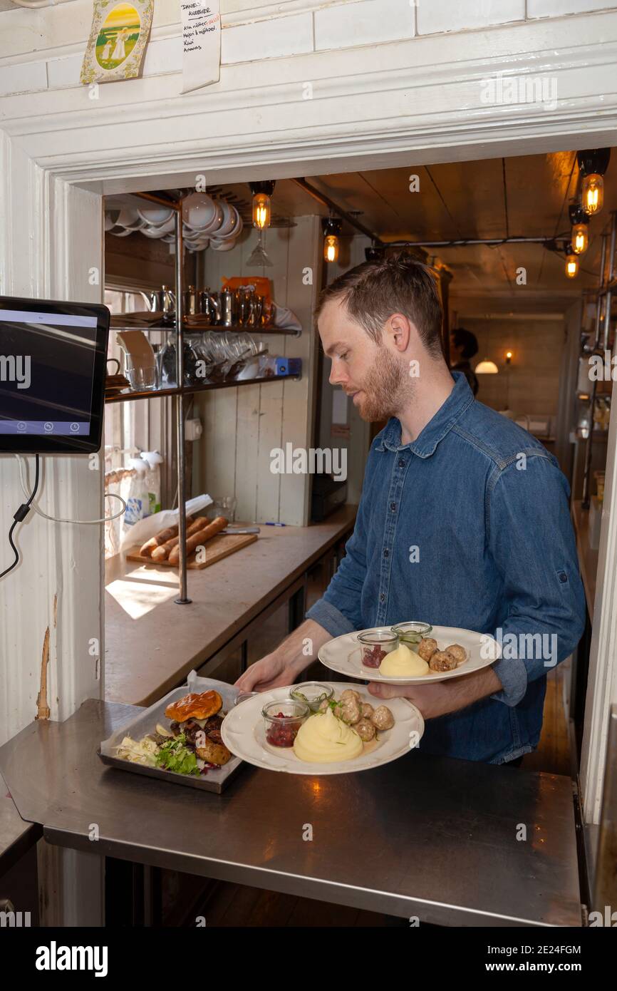 Waiter taking plates with food Stock Photo - Alamy