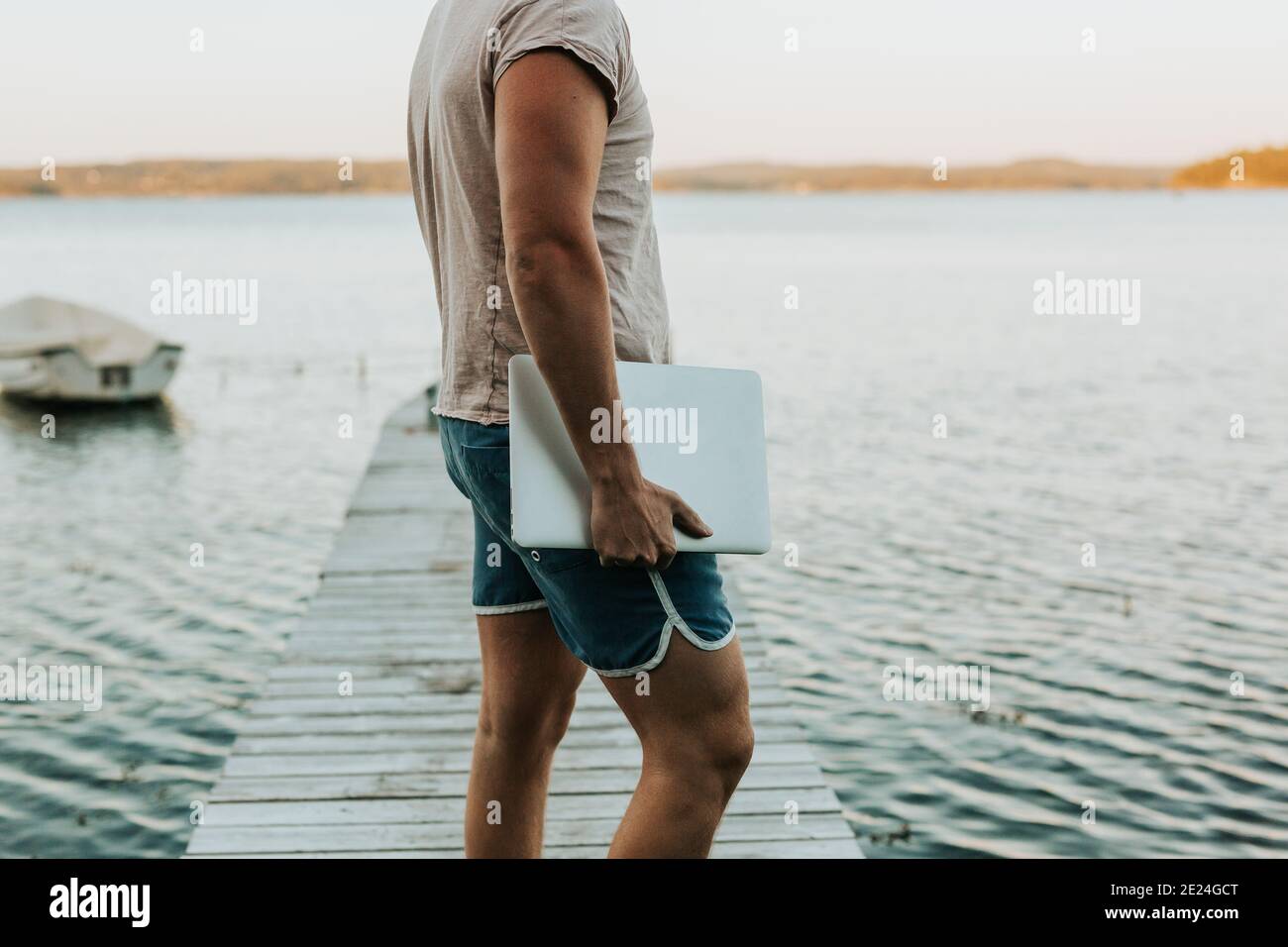 Young man standing jetty hi-res stock photography and images - Alamy
