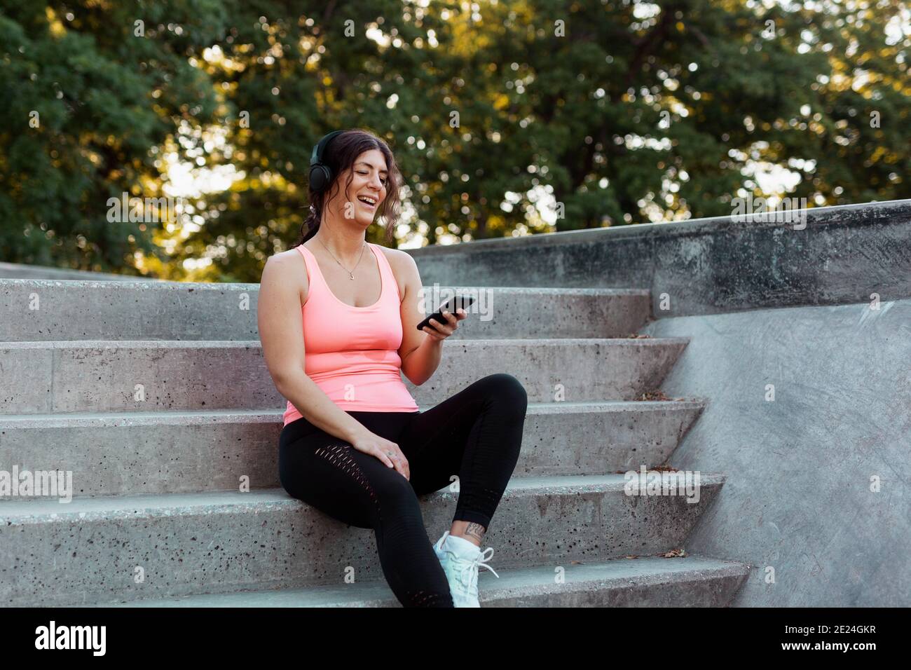 Woman on stairs using cell phone Stock Photo - Alamy