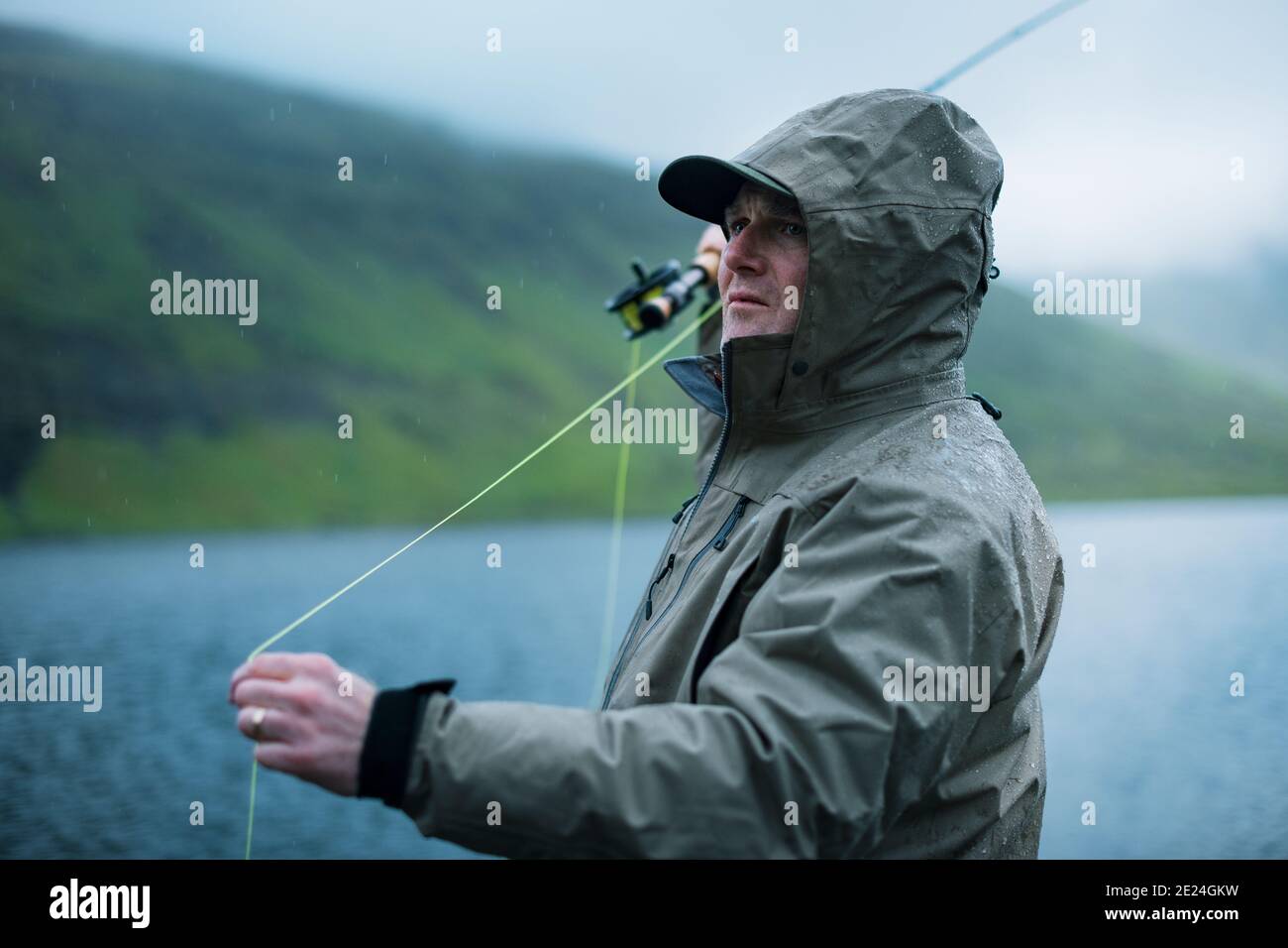 Man fly fishing in lake Stock Photo - Alamy