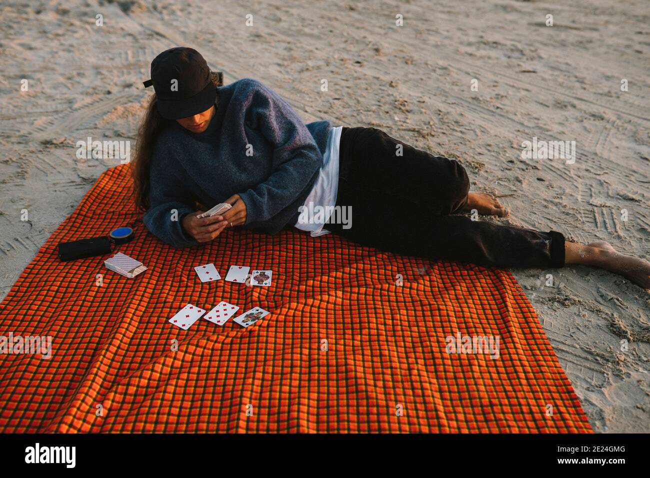 Woman playing cards on beach Stock Photo - Alamy