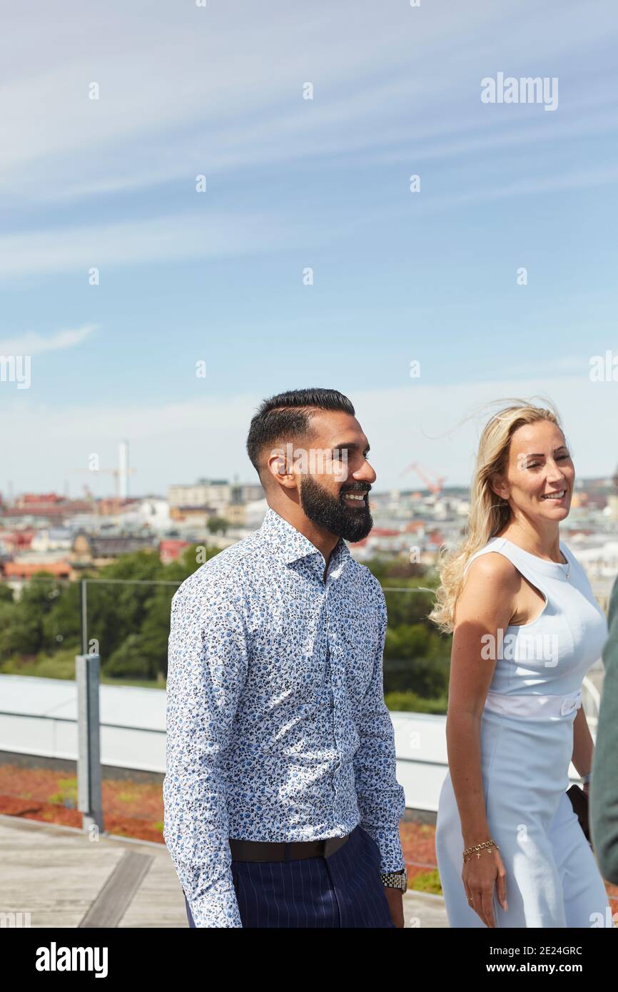 Smiling coworkers talking Stock Photo - Alamy