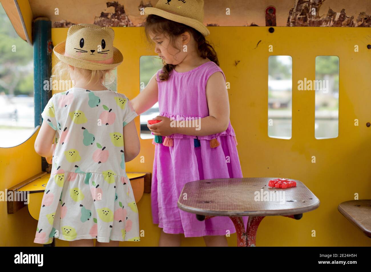 Girls playing together in playhouse Stock Photo - Alamy