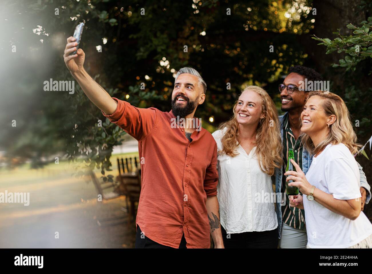 Smiling friends taking selfie Stock Photo - Alamy
