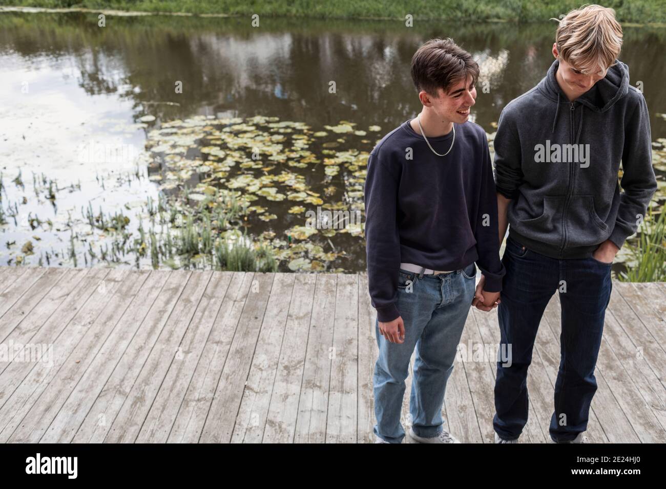 Two boys holding hands hi-res stock photography and images - Alamy