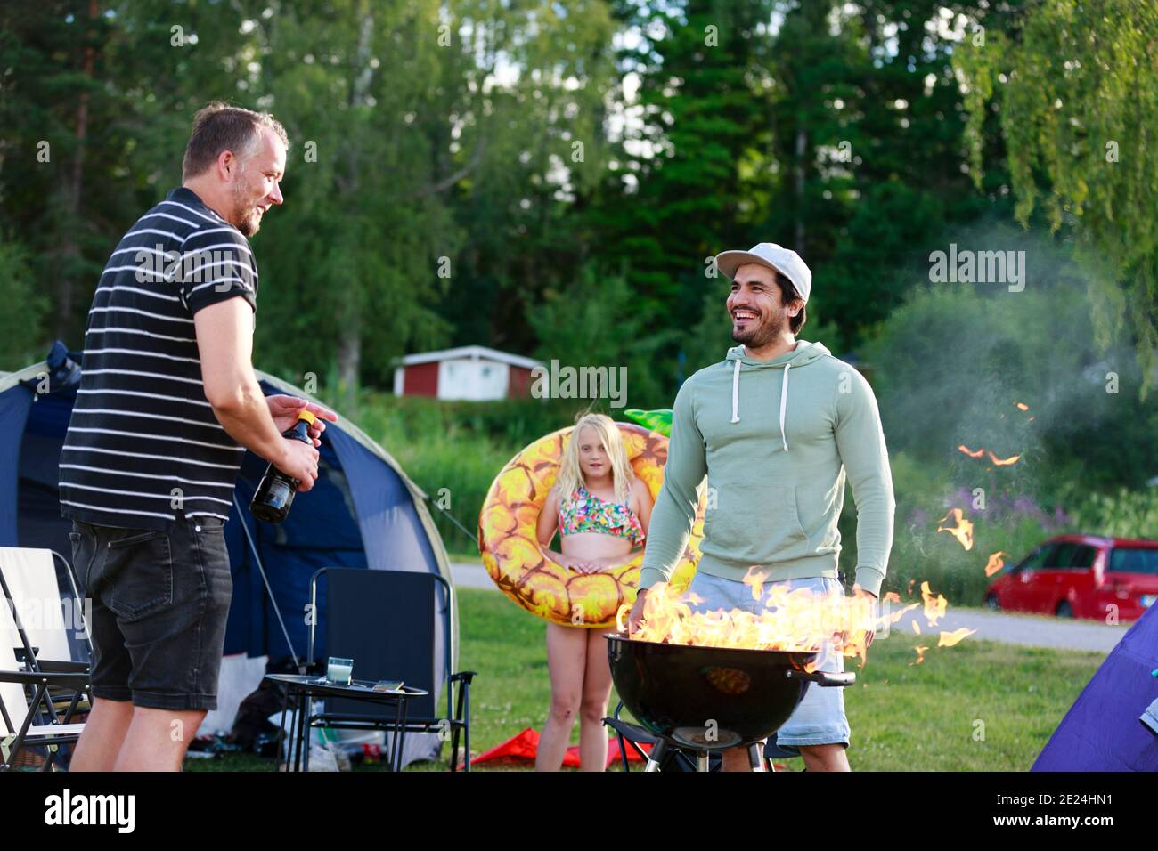 Family having barbecue on campsite Stock Photo - Alamy
