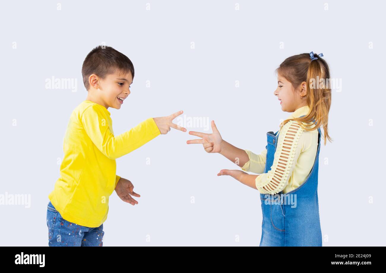 Cute kids play stone, paper scissors and have fun on a white background ...