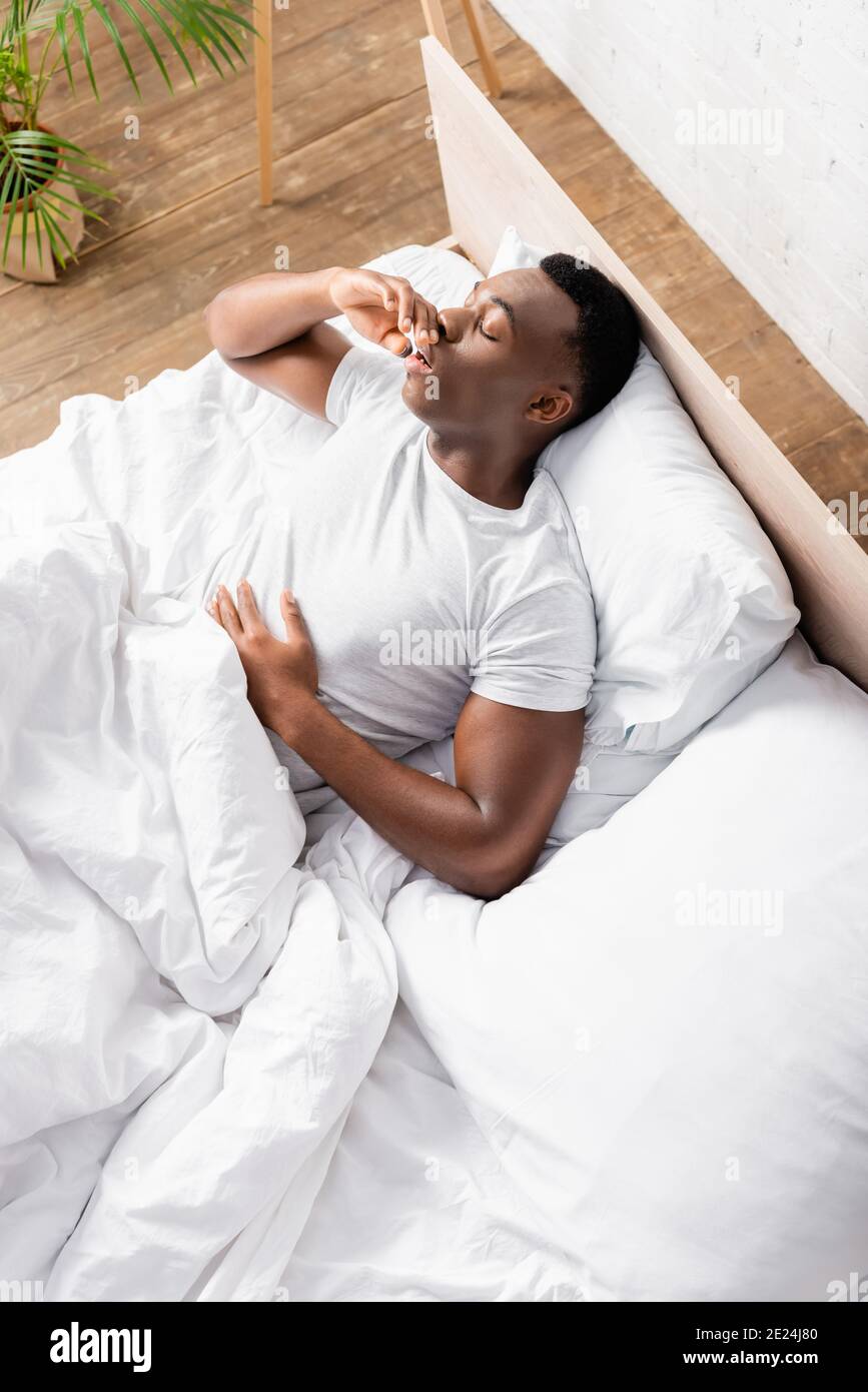 African man sleeping on bed hi-res stock photography and images - Alamy