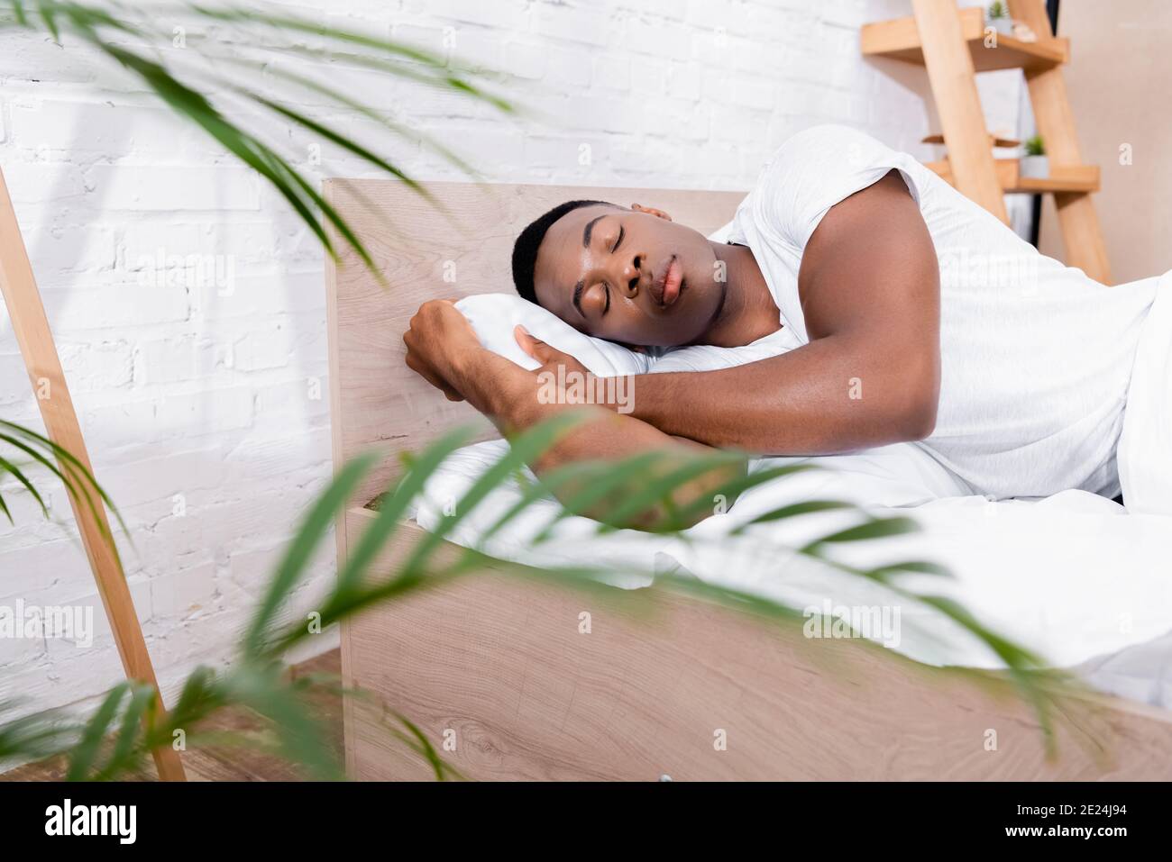 African man sleeping on bed hi-res stock photography and images - Alamy