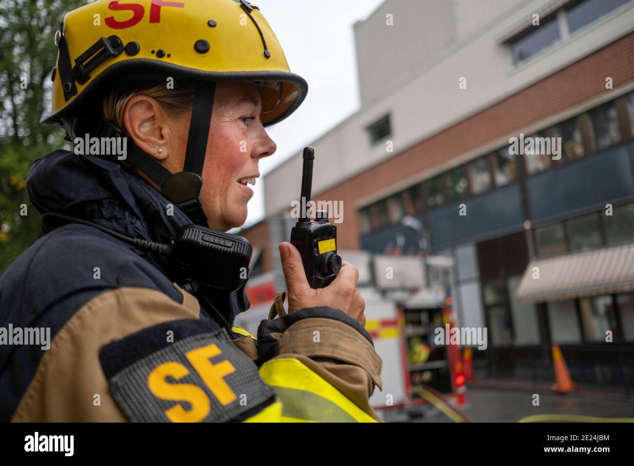 Firefighter talking via walkie talkie Stock Photo - Alamy