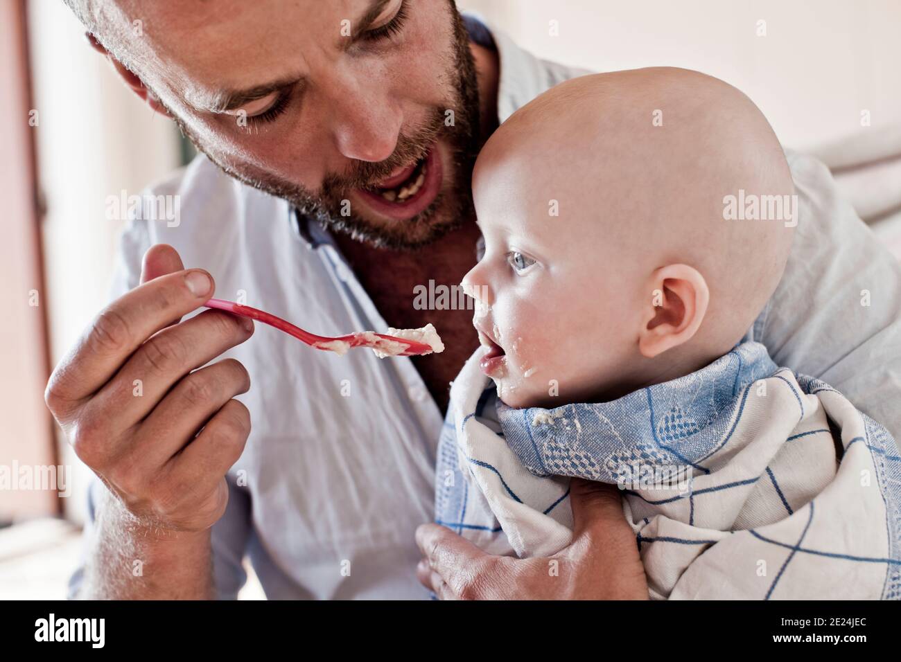 Father feeding baby Stock Photo - Alamy