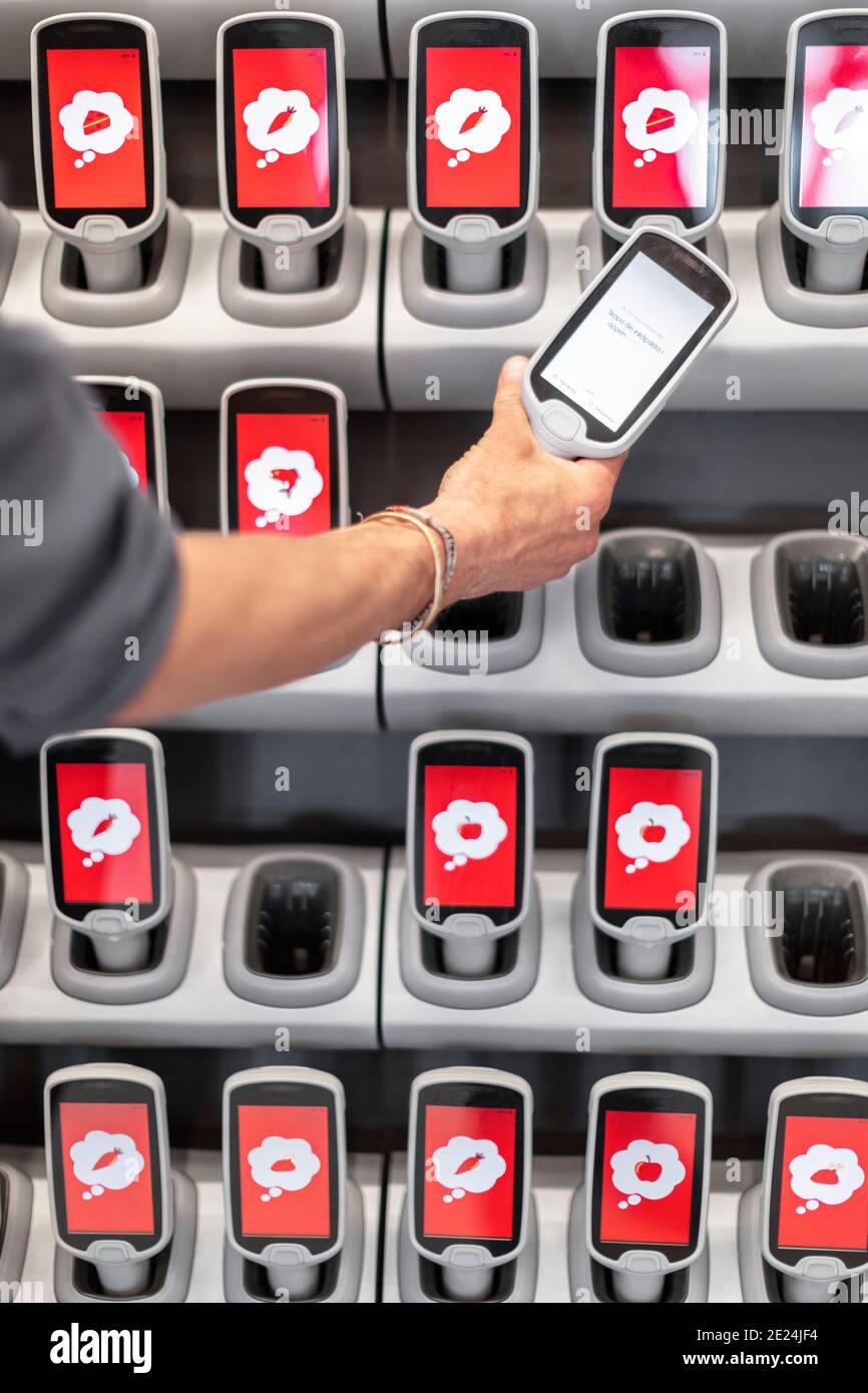 Mans hand holding barcode reader Stock Photo - Alamy