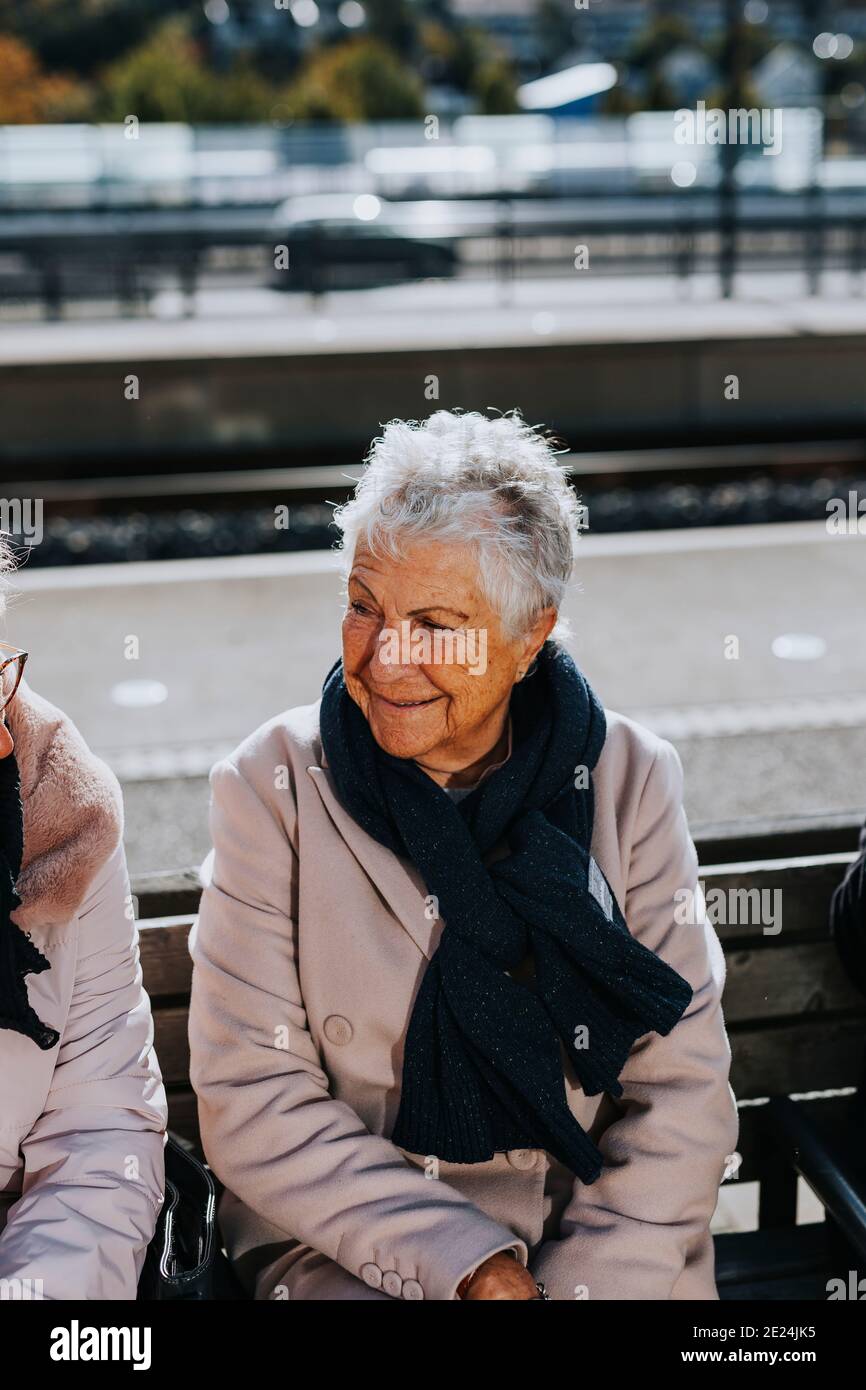 Woman on train station platform Stock Photo - Alamy