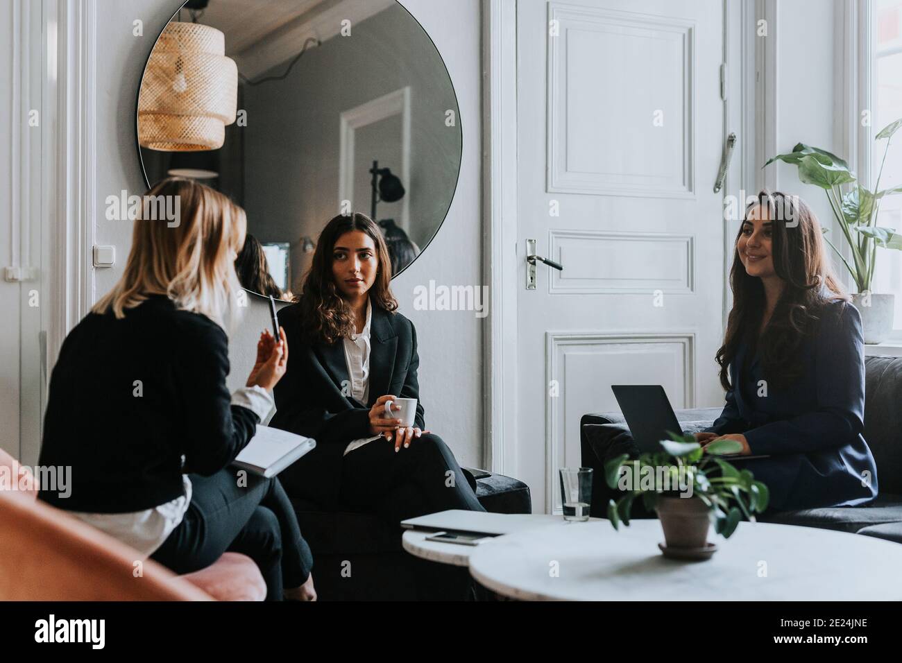 Female coworkers in office Stock Photo - Alamy