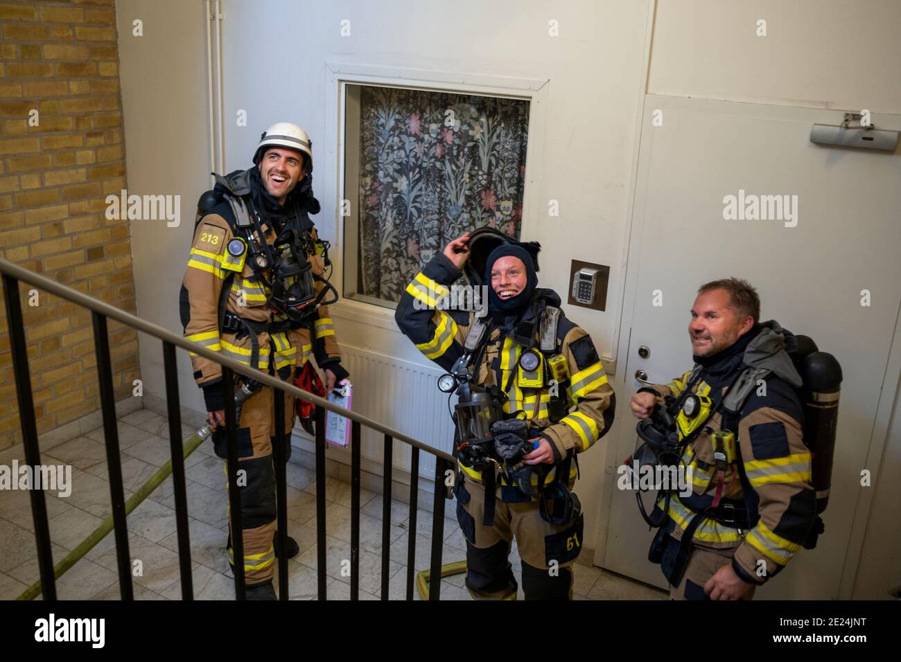 Firefighter on staircase Stock Photo - Alamy