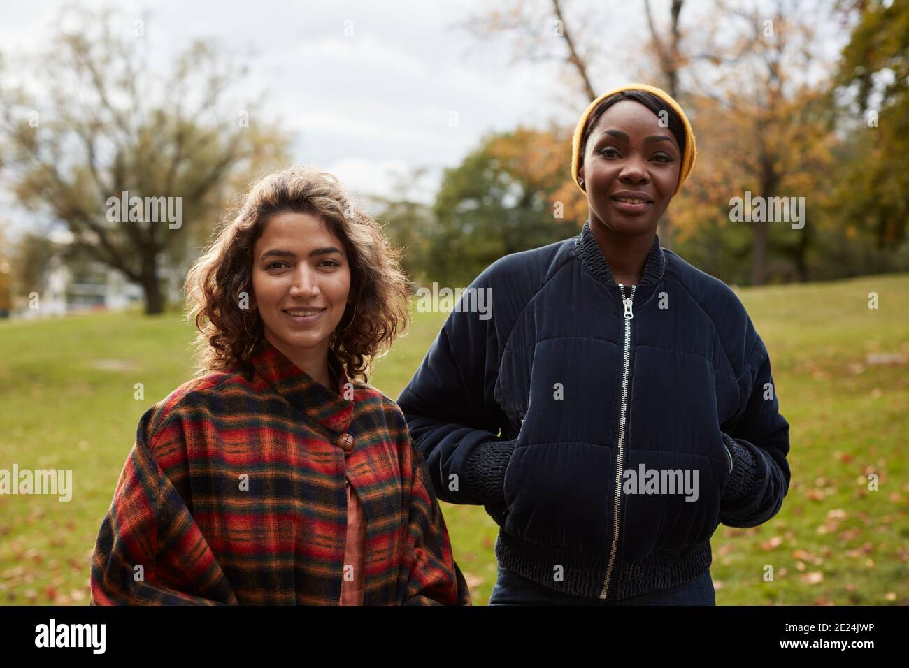 Female friends looking at camera Stock Photo - Alamy
