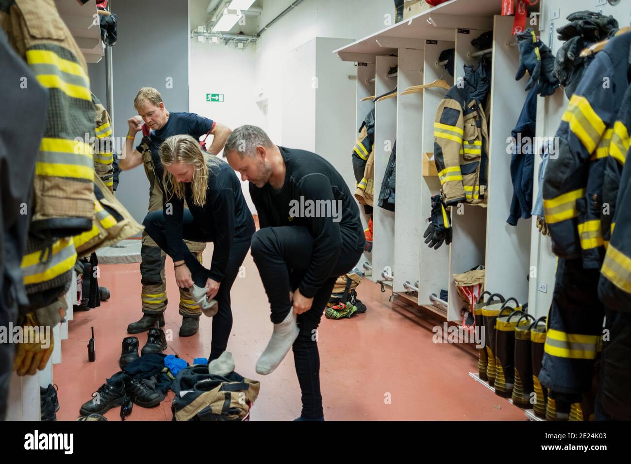 Firefighters changing in locker Stock Photo - Alamy