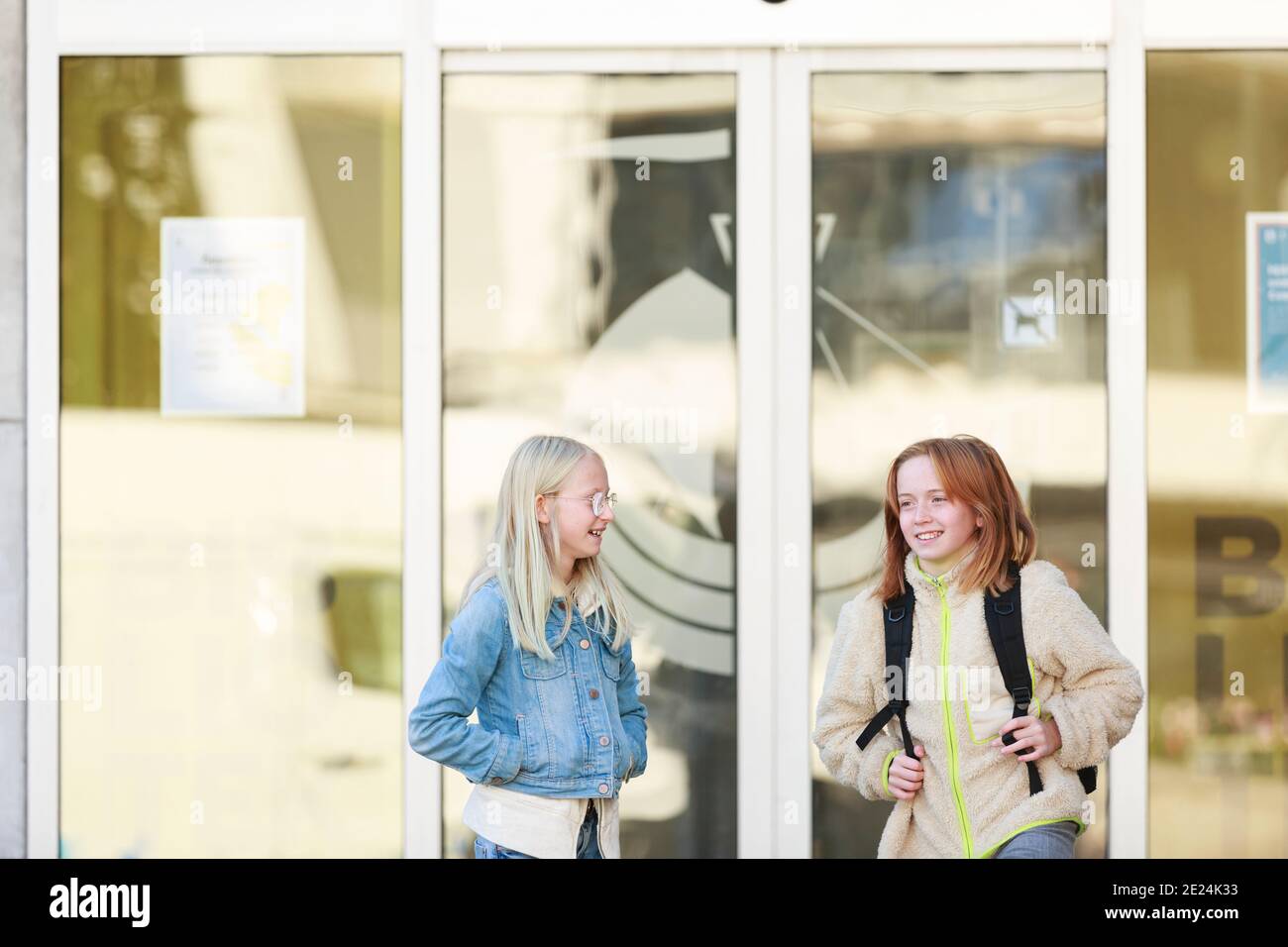 Girl standing in front of library Stock Photo - Alamy