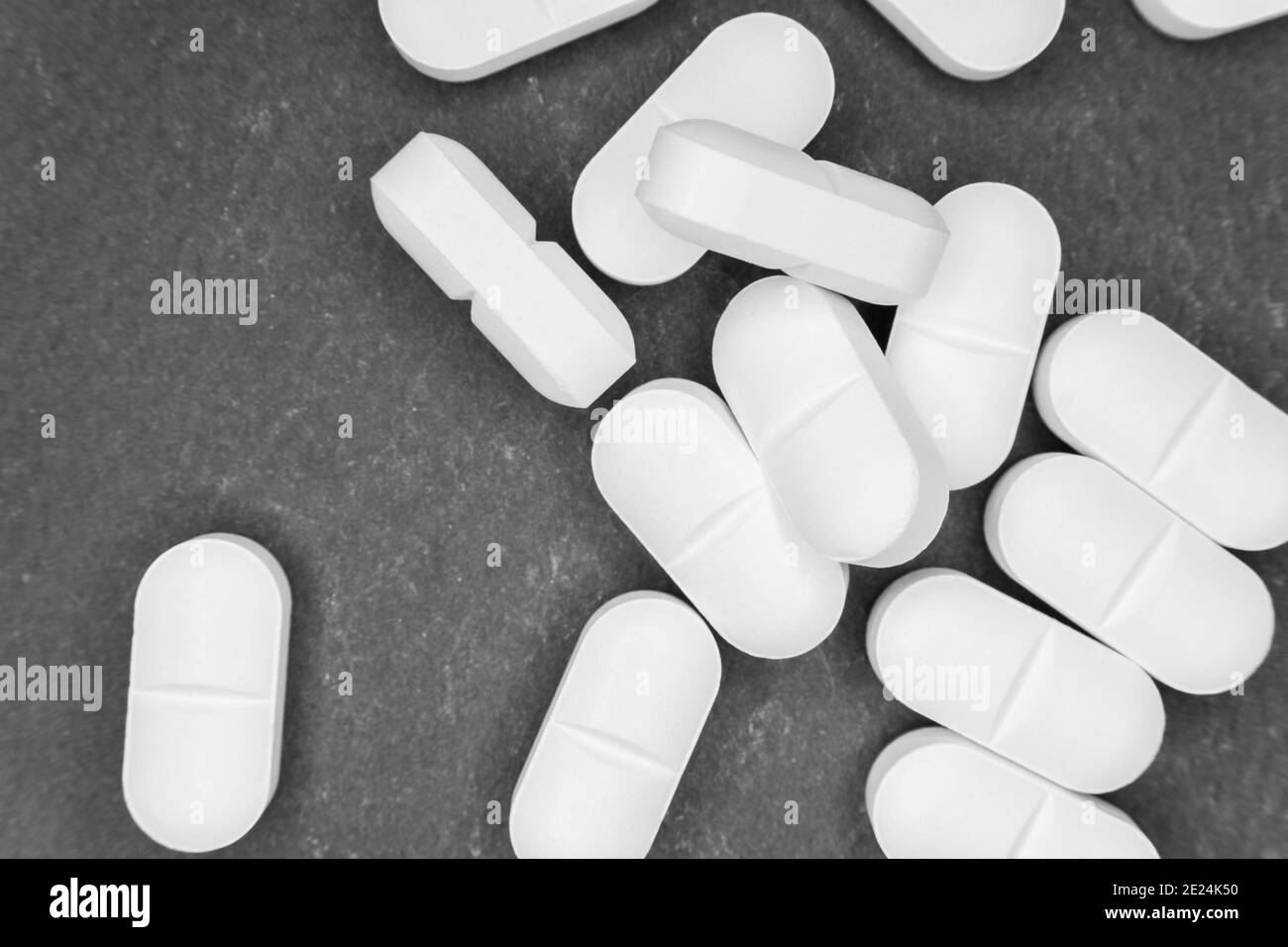 Closeup of medicine tablets on a grey surface Stock Photo - Alamy