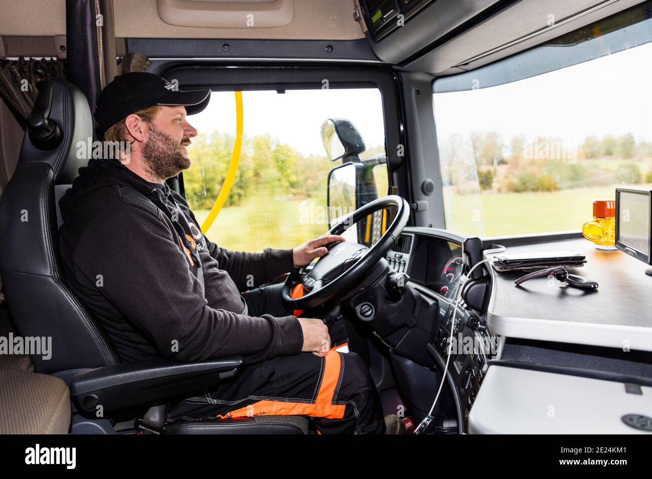 Farmer driving combine harvester Stock Photo - Alamy