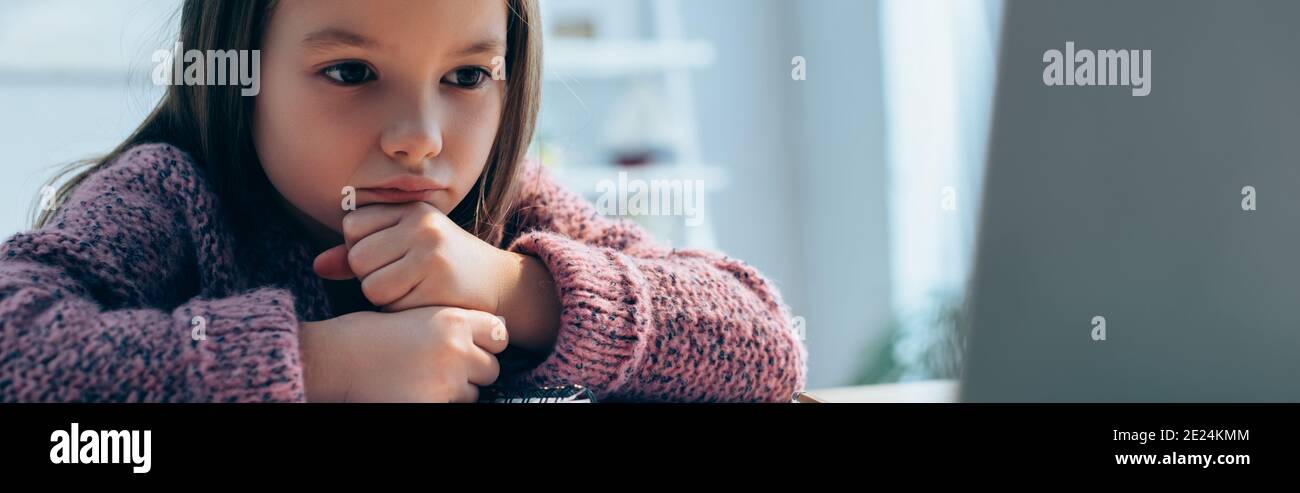 Sad girl looking at blurred laptop on foreground, banner Stock Photo ...