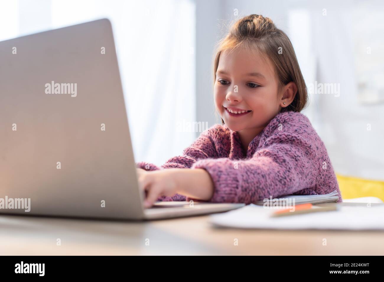 Girl smiling on the while typing hi-res stock photography and images ...