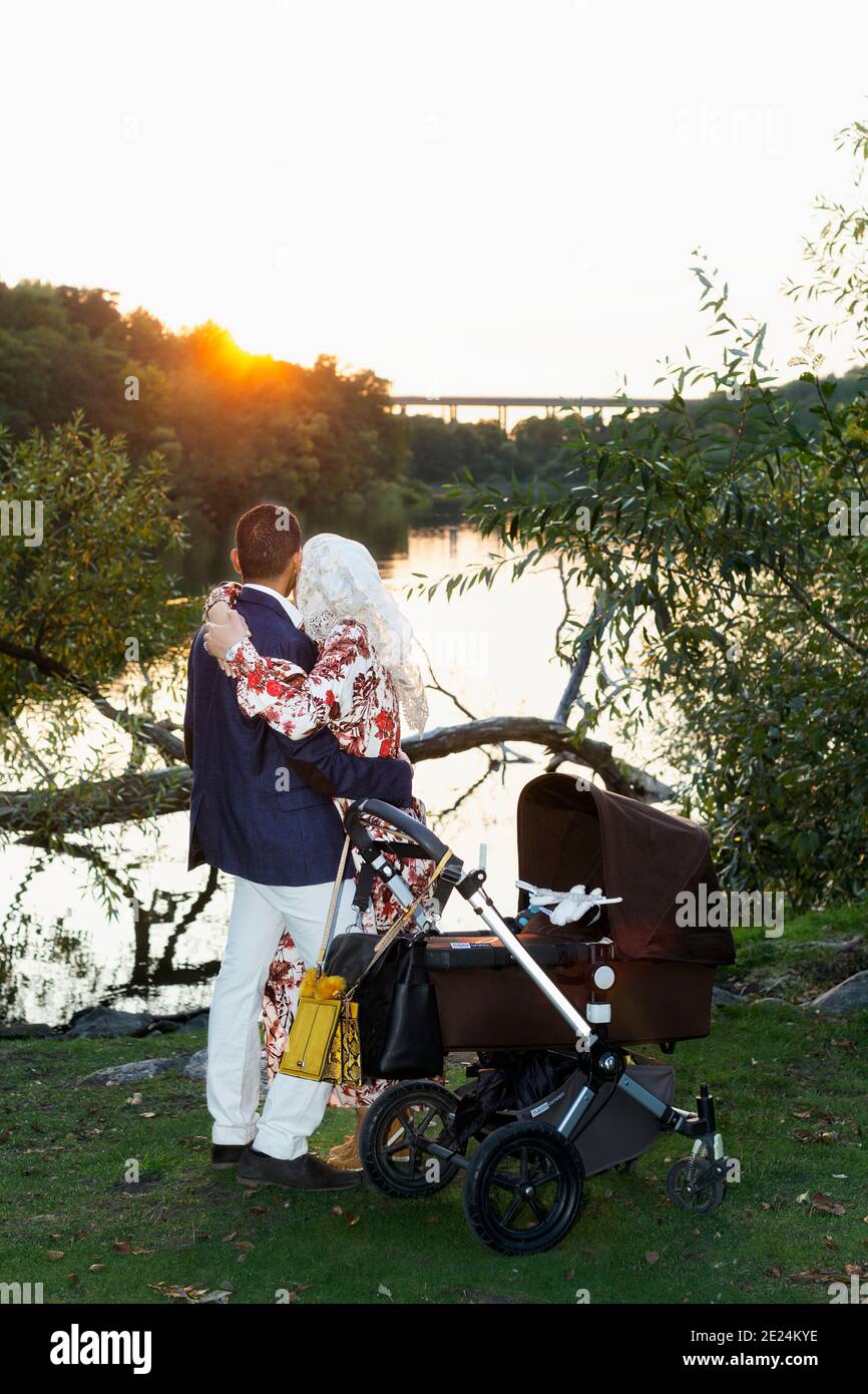 Parents with pram at lake Stock Photo - Alamy