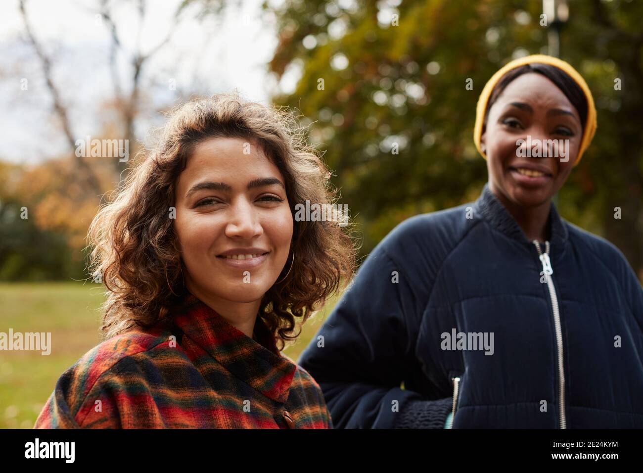 Female friends looking at camera Stock Photo - Alamy