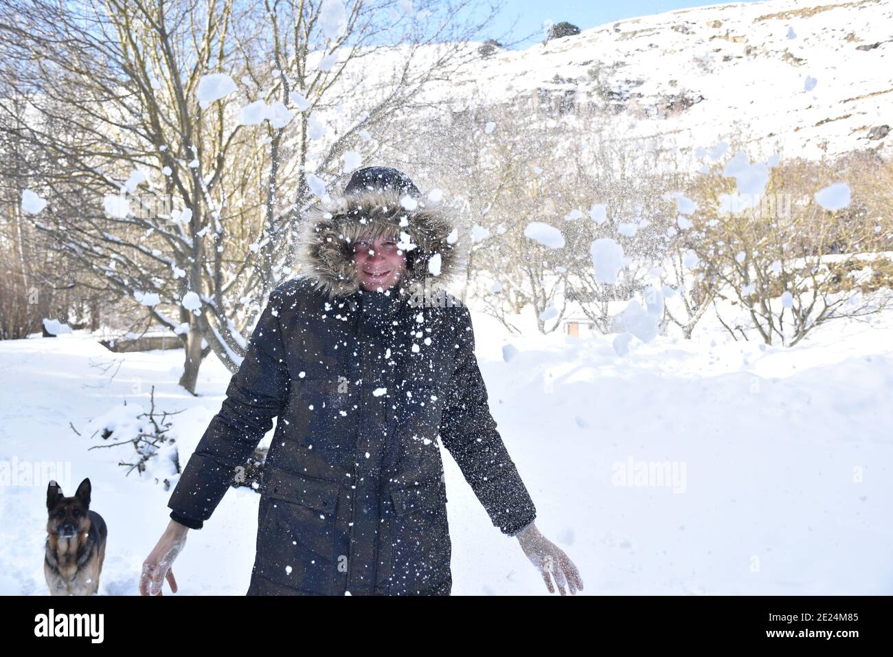 Snow falling to the ground after being thrown upwards, happy smiling ...