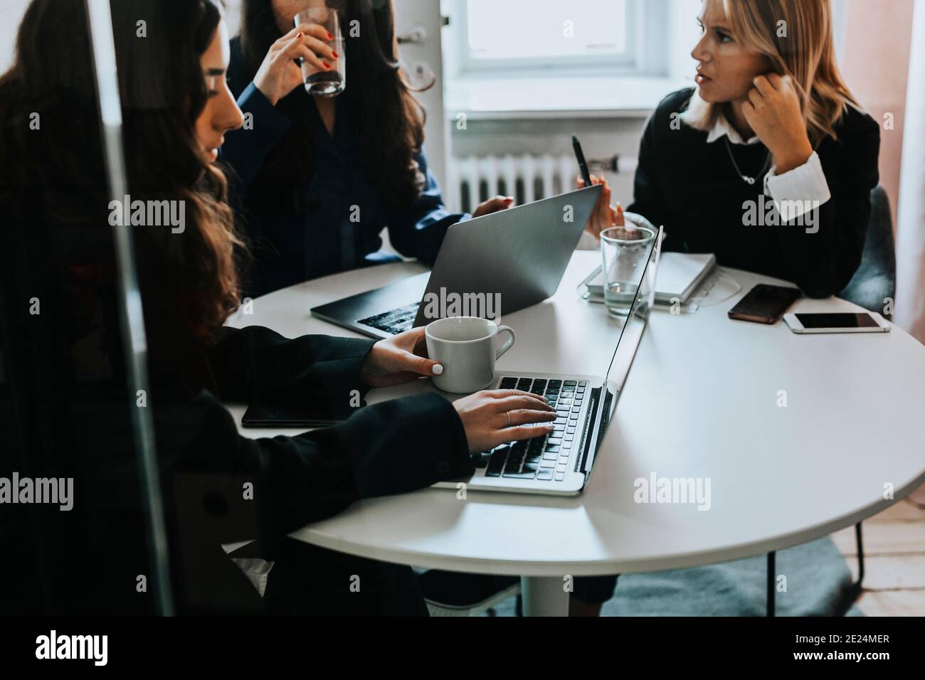 Female coworkers in office Stock Photo - Alamy